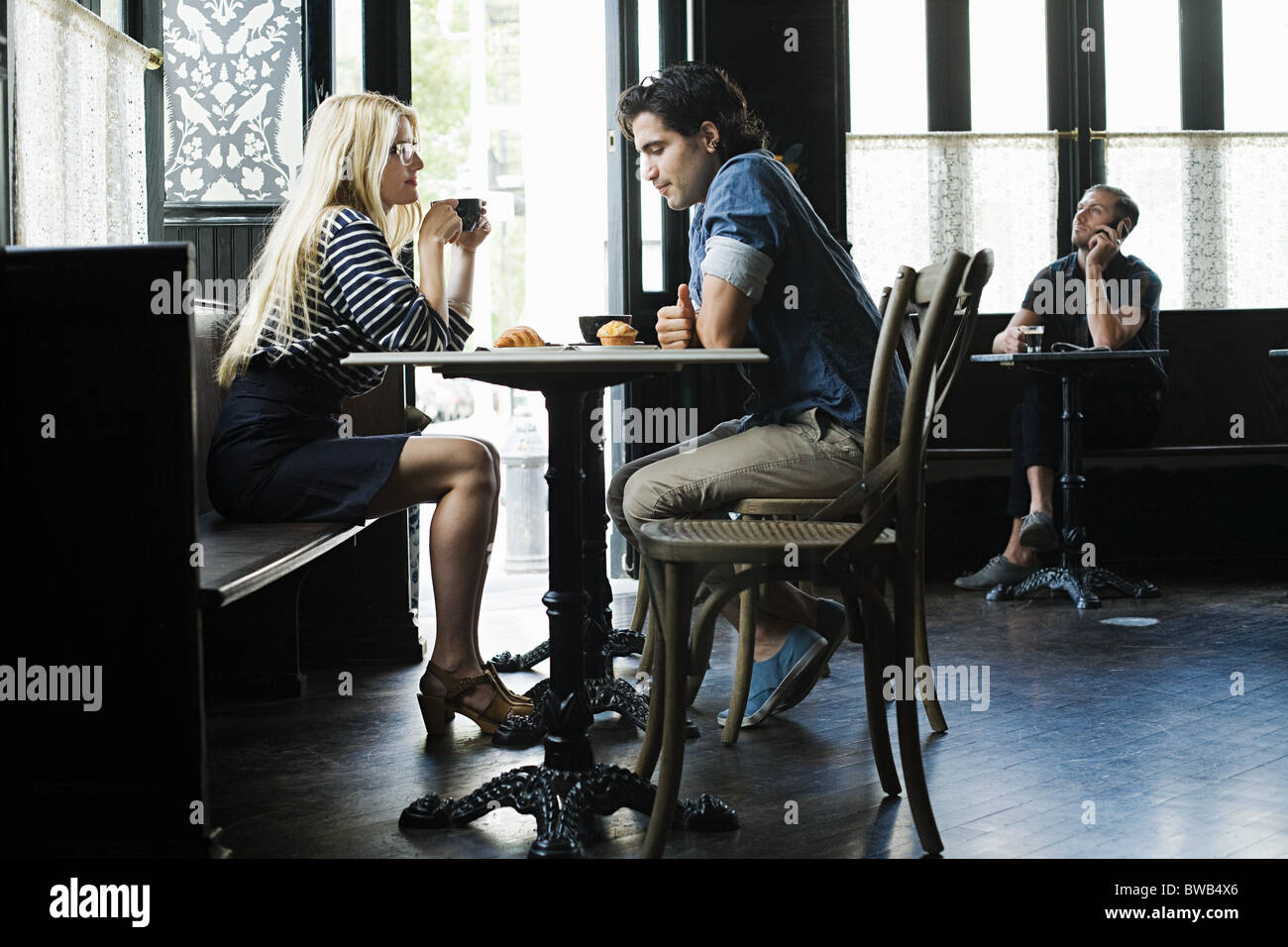 Couple having coffee in cafe Stock Photo - Alamy