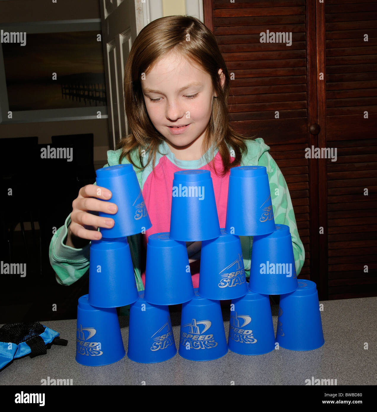 Young girl playing Speed Stacks using blue stacking cups Stock Photo ...