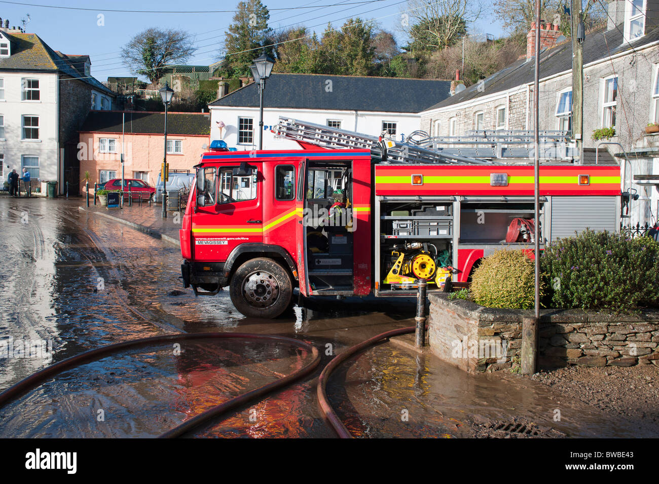 A fire engine pumps water from a house in Pentewan Cornwall after the ...