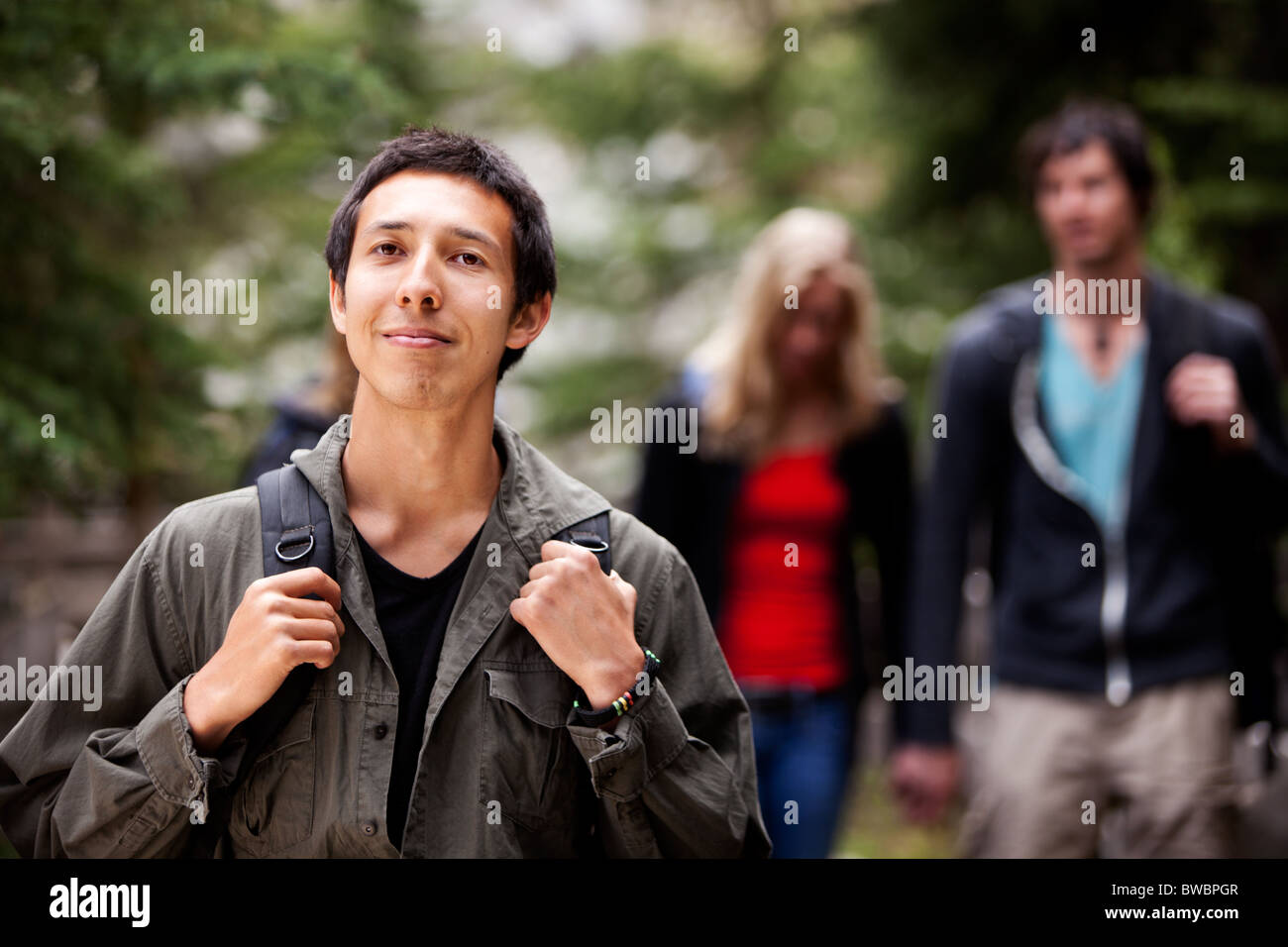 A man backpack camping in the forest with a group of friends in the ...
