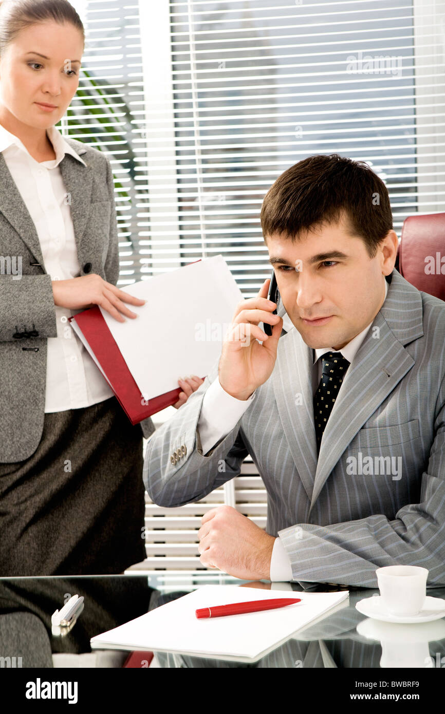 Portrait of confident boss talking on the phone with executive ...