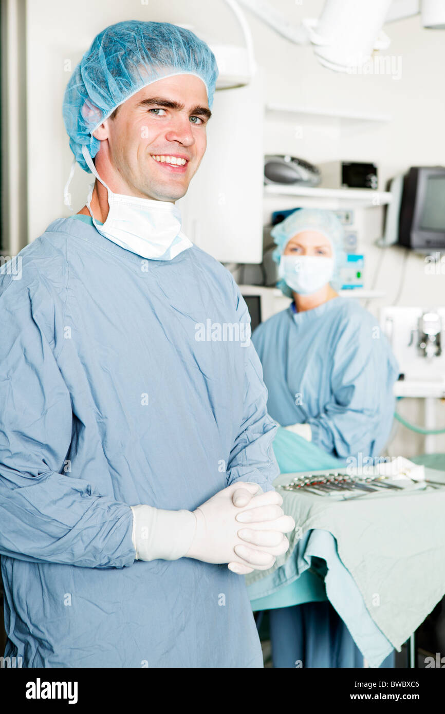 A portrait of a male surgeon with an operation theater in the ...