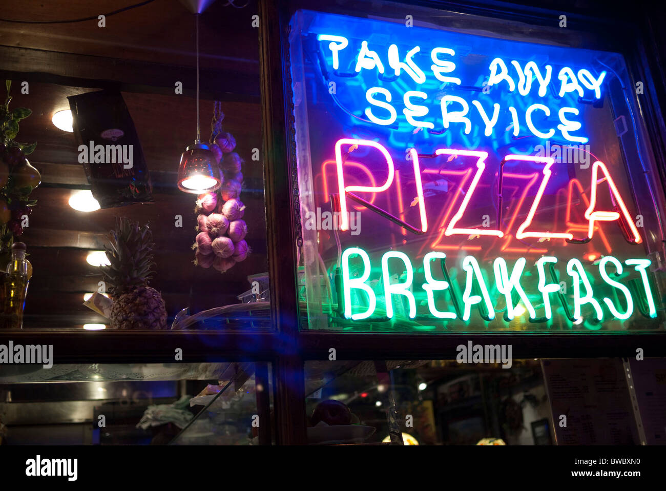 Neon pizza take away sign outside a restaurant in London Stock Photo ...