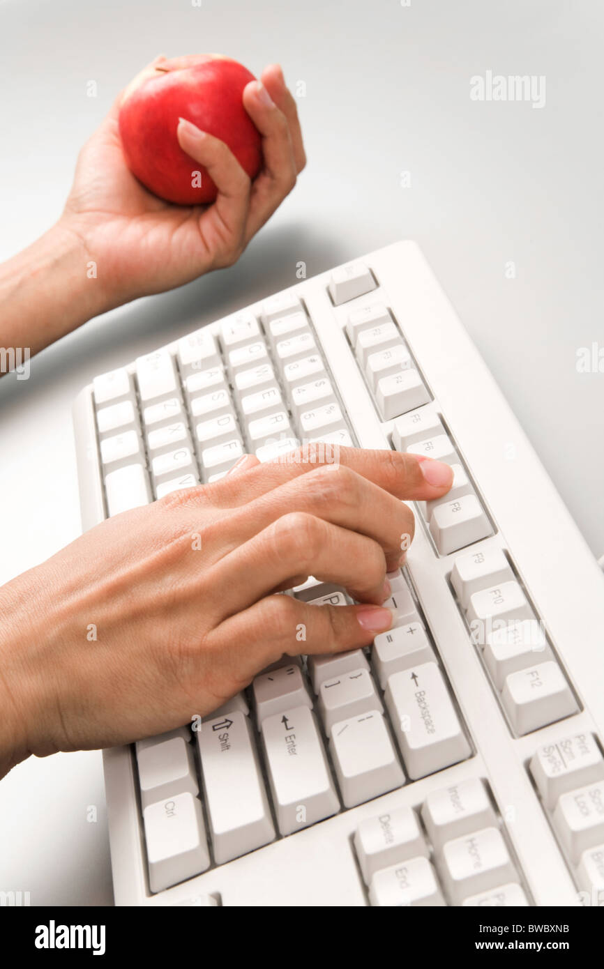 Close-up of female hand pressing buttons of computer keyboard and ...