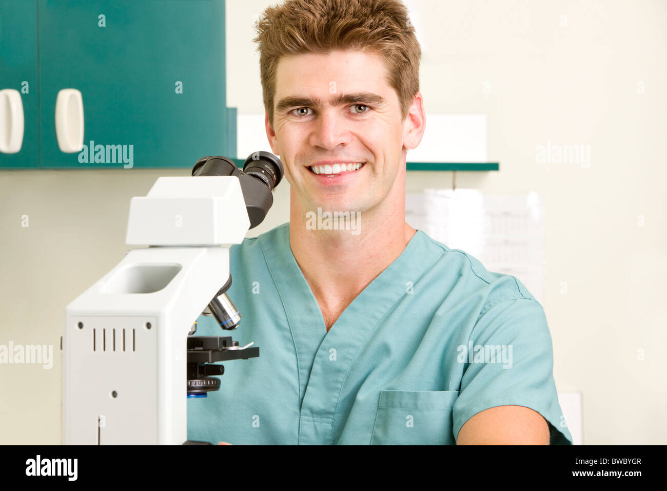 A doctor looking through a microscope Stock Photo - Alamy