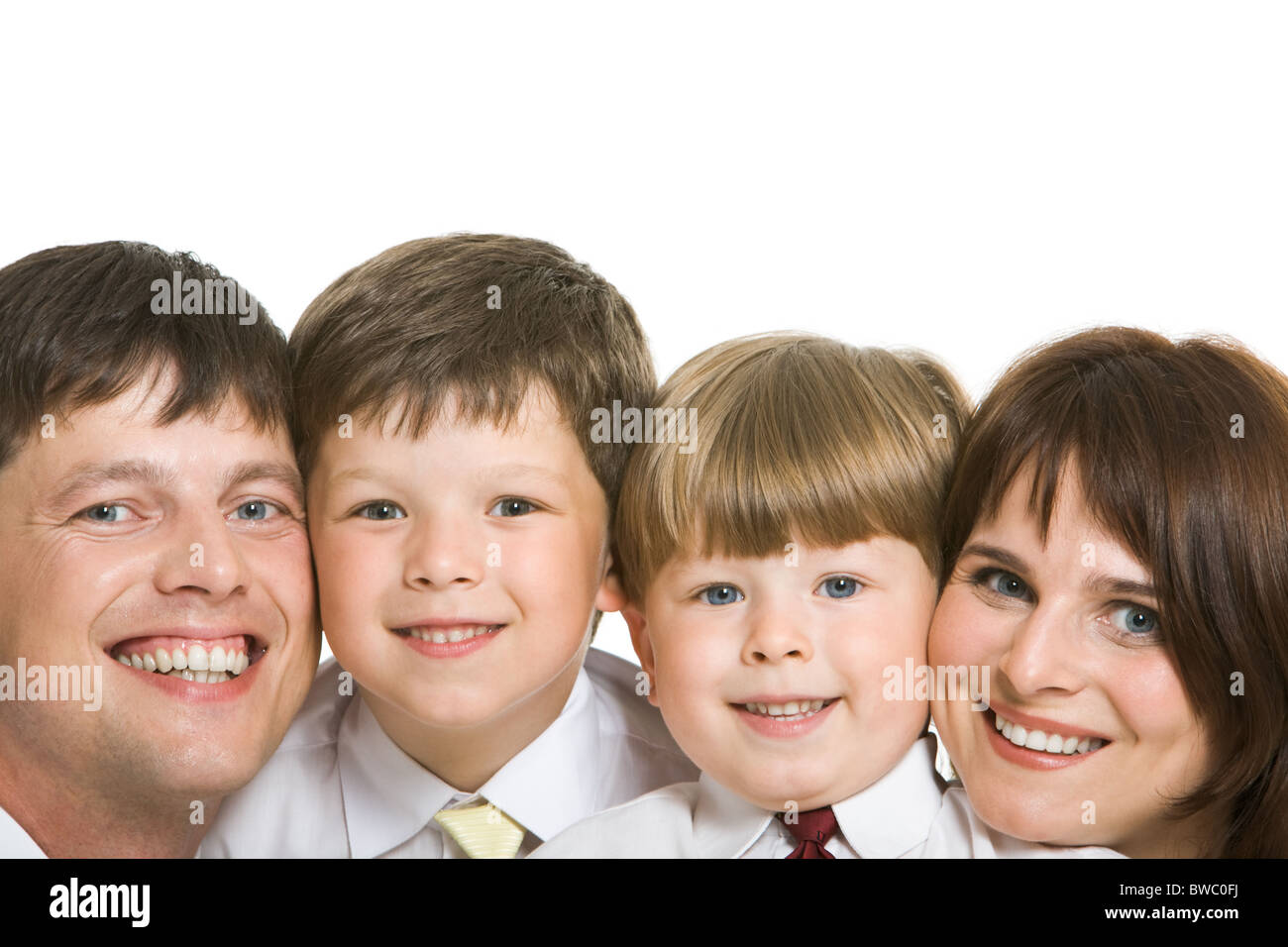 Faces of four family members looking at camera with happy smiles Stock ...