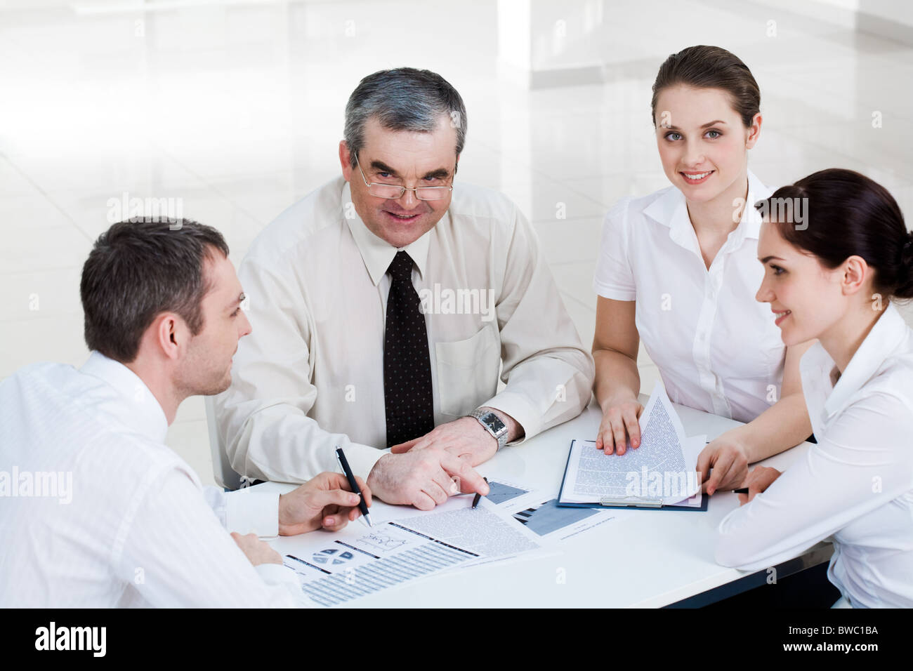 Photo of confident co-workers planning new project at briefing Stock ...