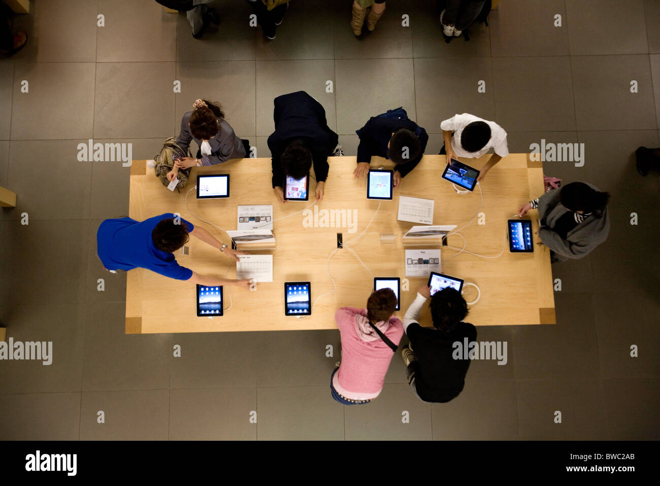 People trying the new I pad at Apple Mac store, Ginza, Tokyo, Japan ...