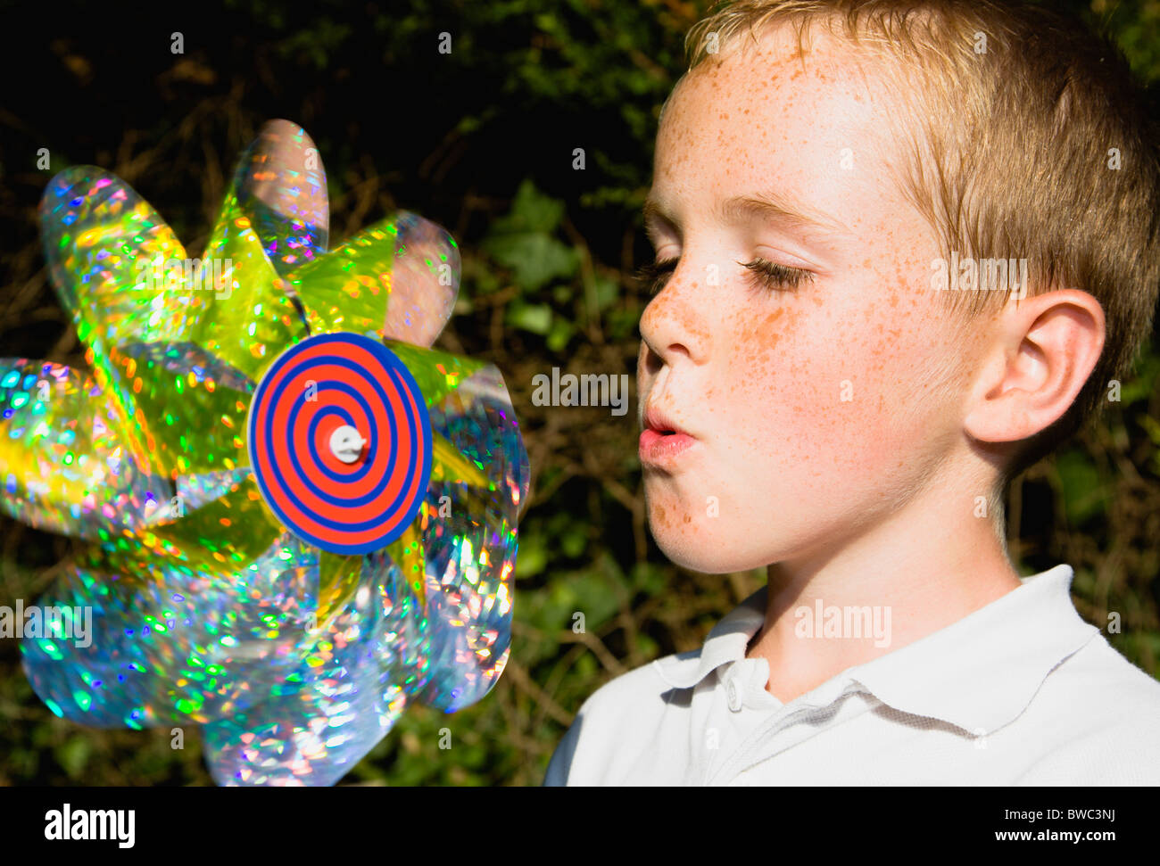 Children, Toys, Outdoors, Young boy blowing toy windmill gently Stock ... Children, Toys, Outdoors, Young boy blowing toy windmill gently Stock ...