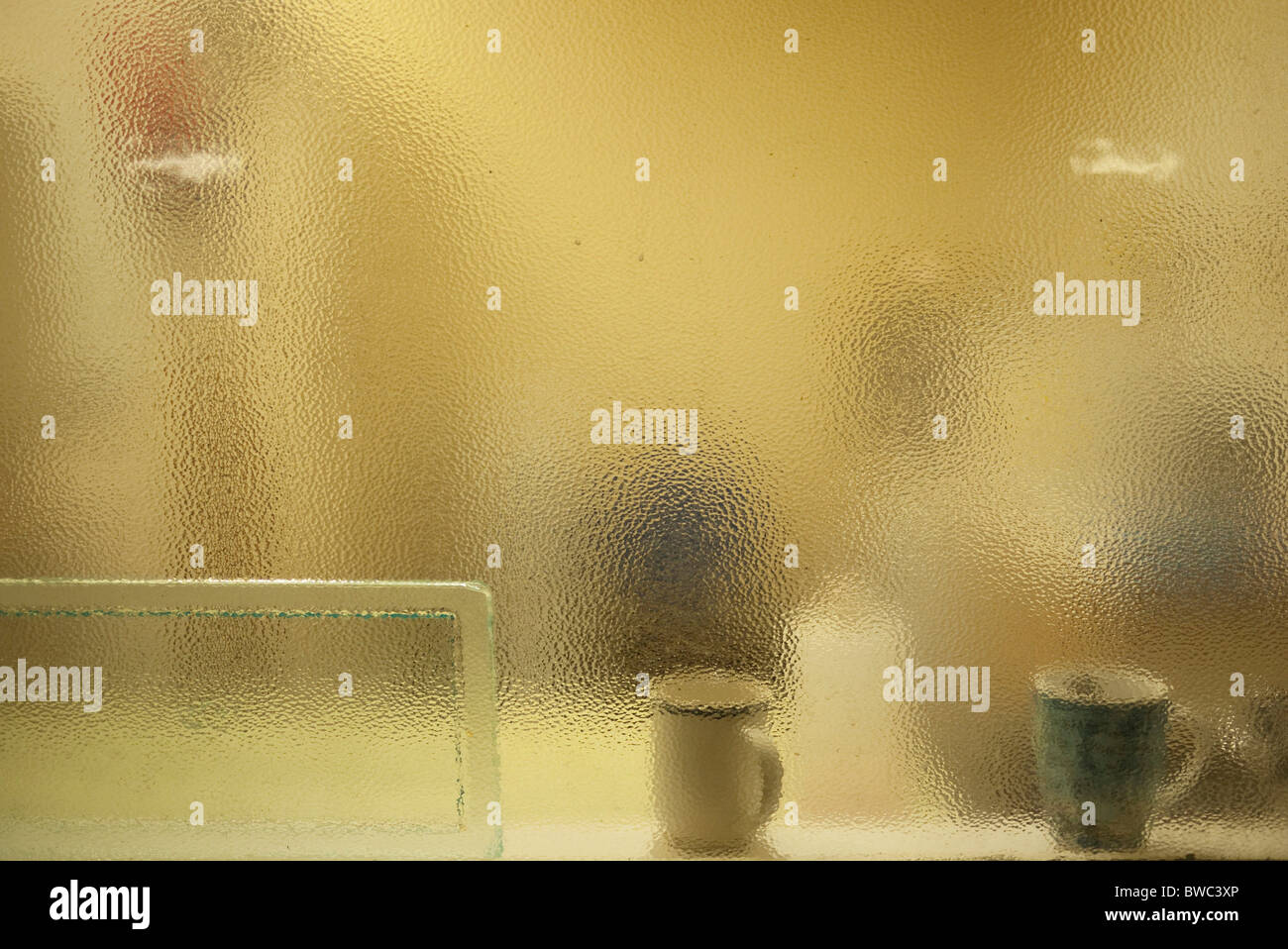 Coffee mugs through a textured glass window Stock Photo - Alamy