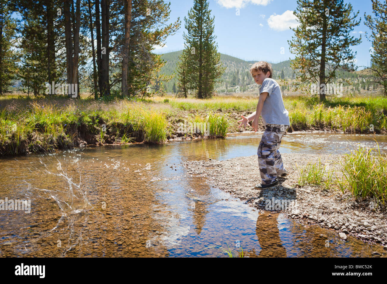 Boy skimming stones Stock Photo - Alamy