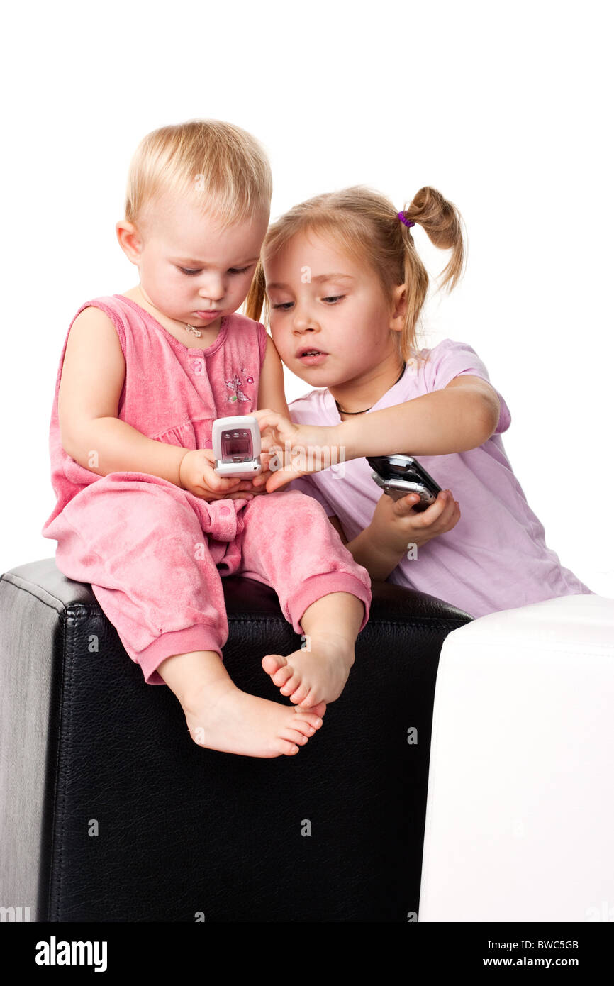 Children looking into the mobile phone isolated on white Stock Photo ...