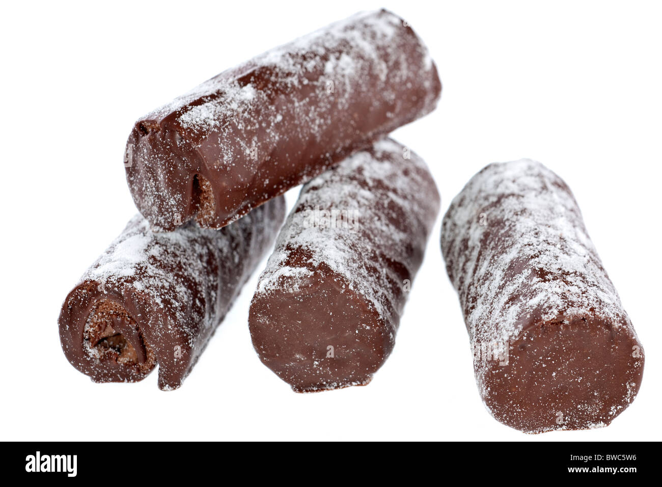 Four small chocolate covered yule logs covered with a sweet icing Stock ...