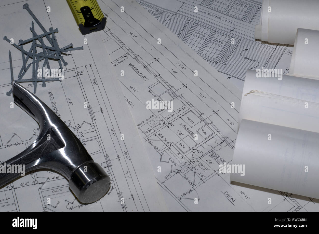 Architect drawings with carpenter tools, hammer, nails and measure ...