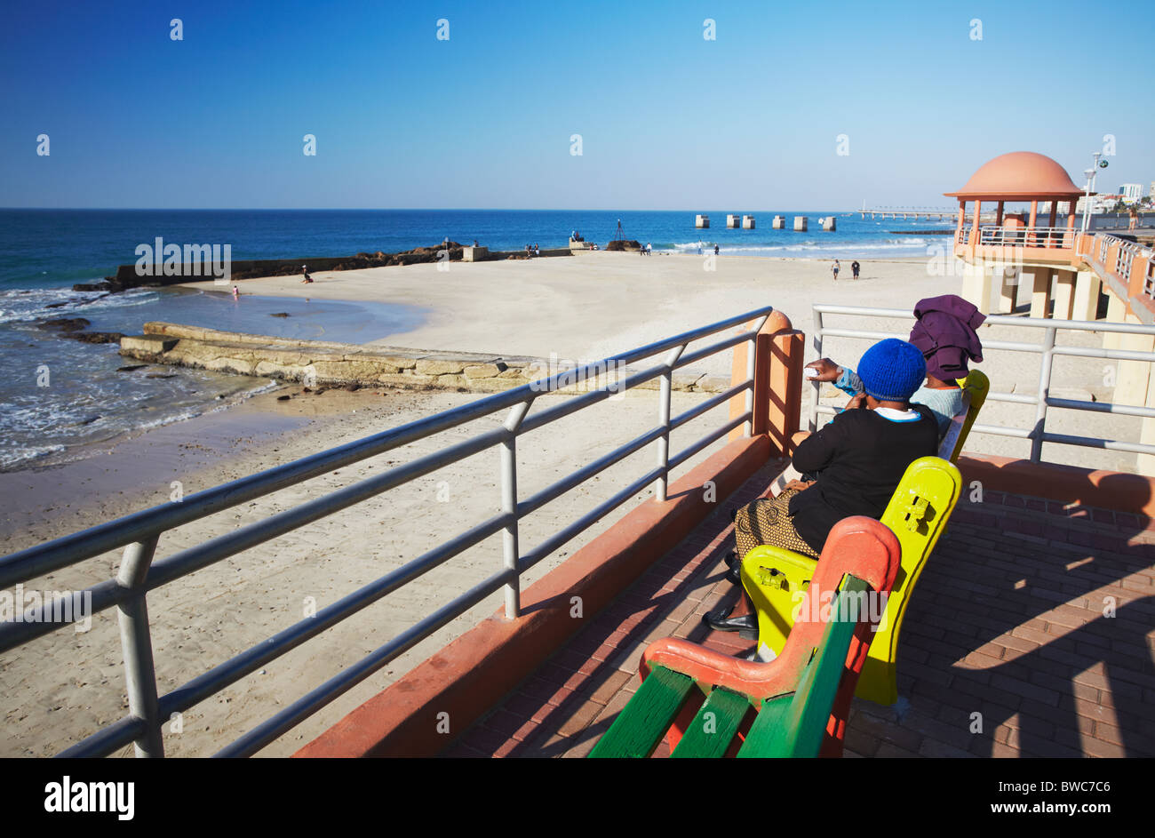 Women sitting on bench at beachfront, Humewood, Port Elizabeth, Eastern ...