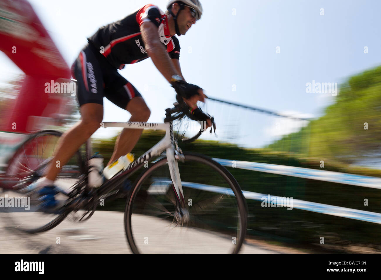 A cyclist races over the finishing line in a cycling race in Provence ...