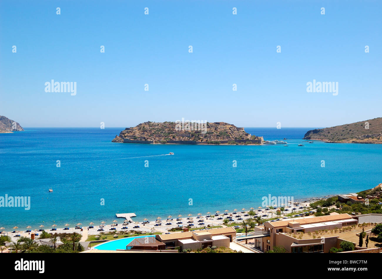 Beach of luxury hotel with a view on Spinalonga Island, Crete, Greece ...