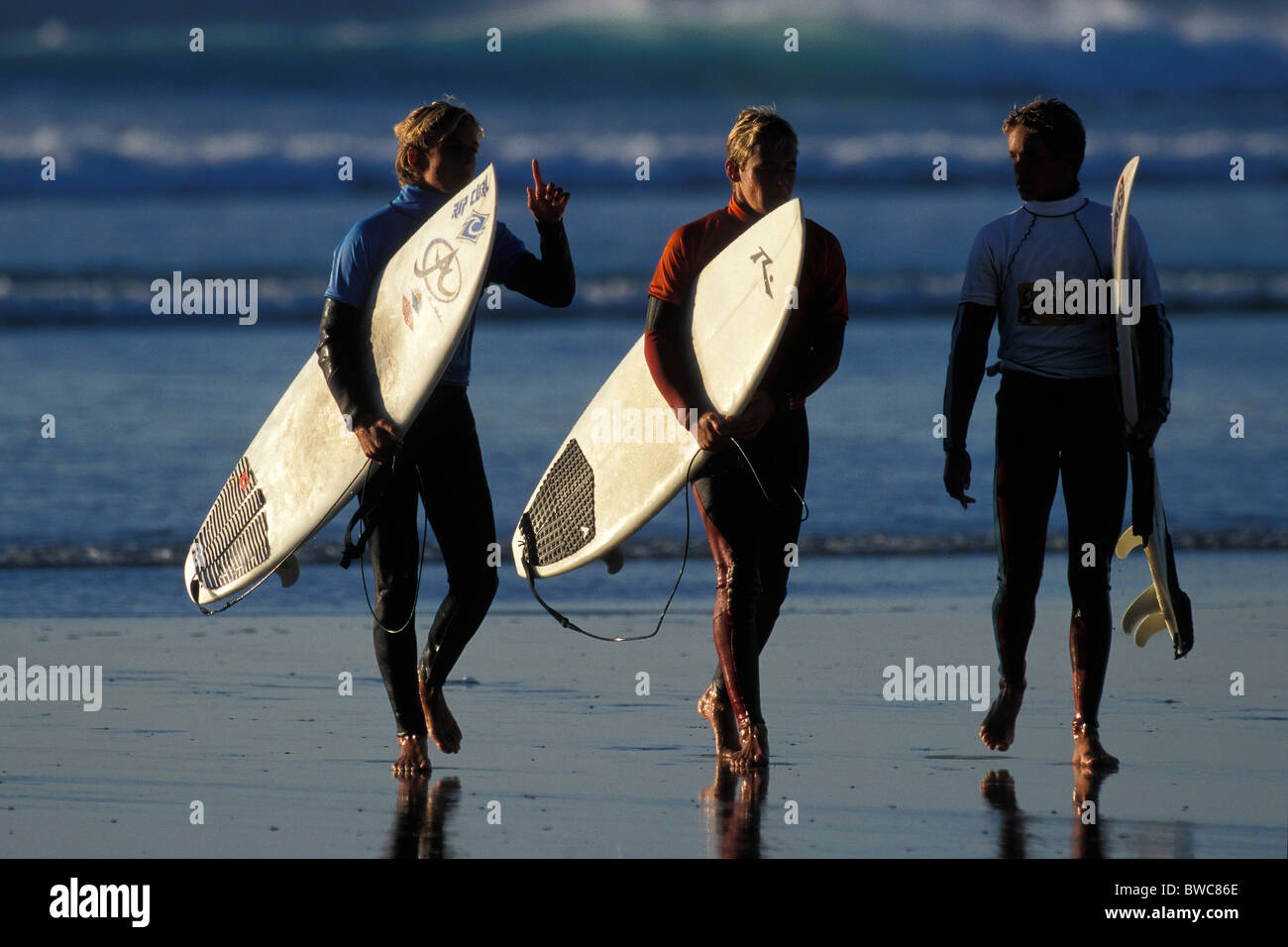 Three surfers chatting as they leave the water at the Festival de la ...
