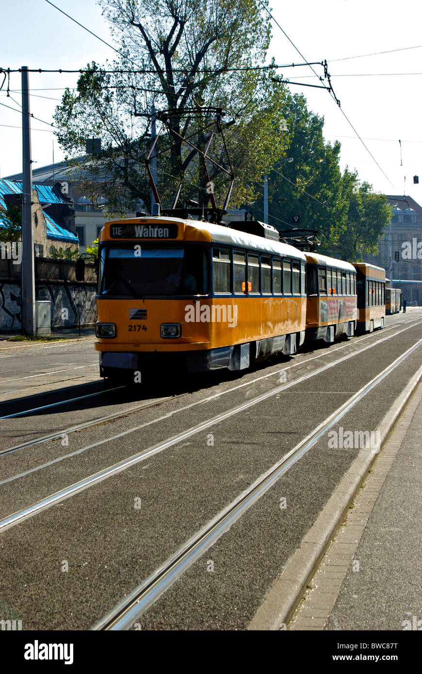 Queue of older triple electric trolley tram car public transit ...