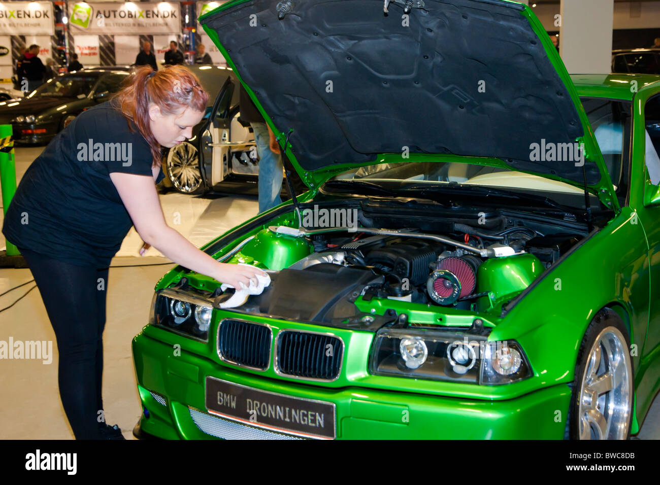 Young female cleaning her racing green BMW car Stock Photo - Alamy