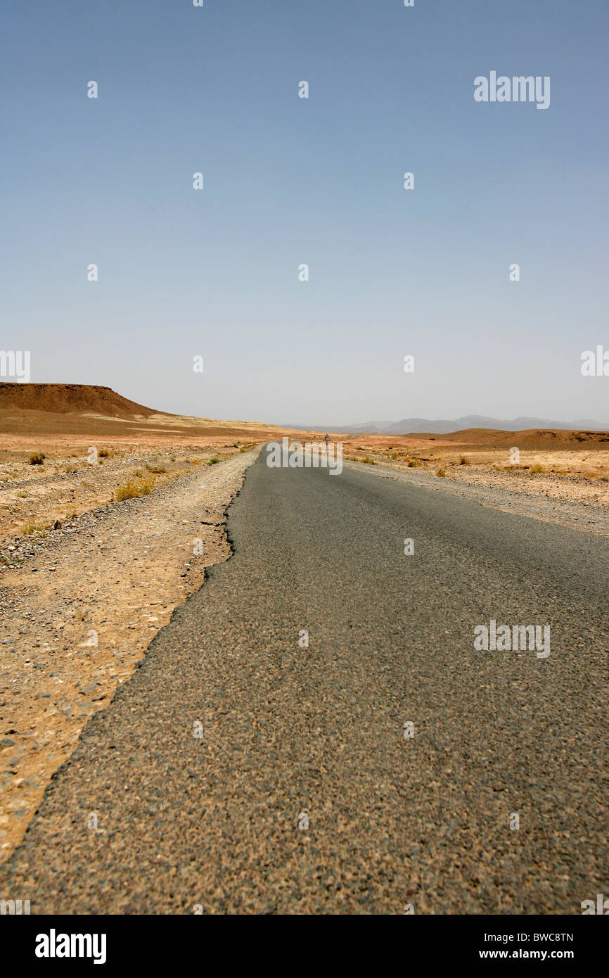 A deserted road in the sahara desert, in southern Morocco Stock Photo ...