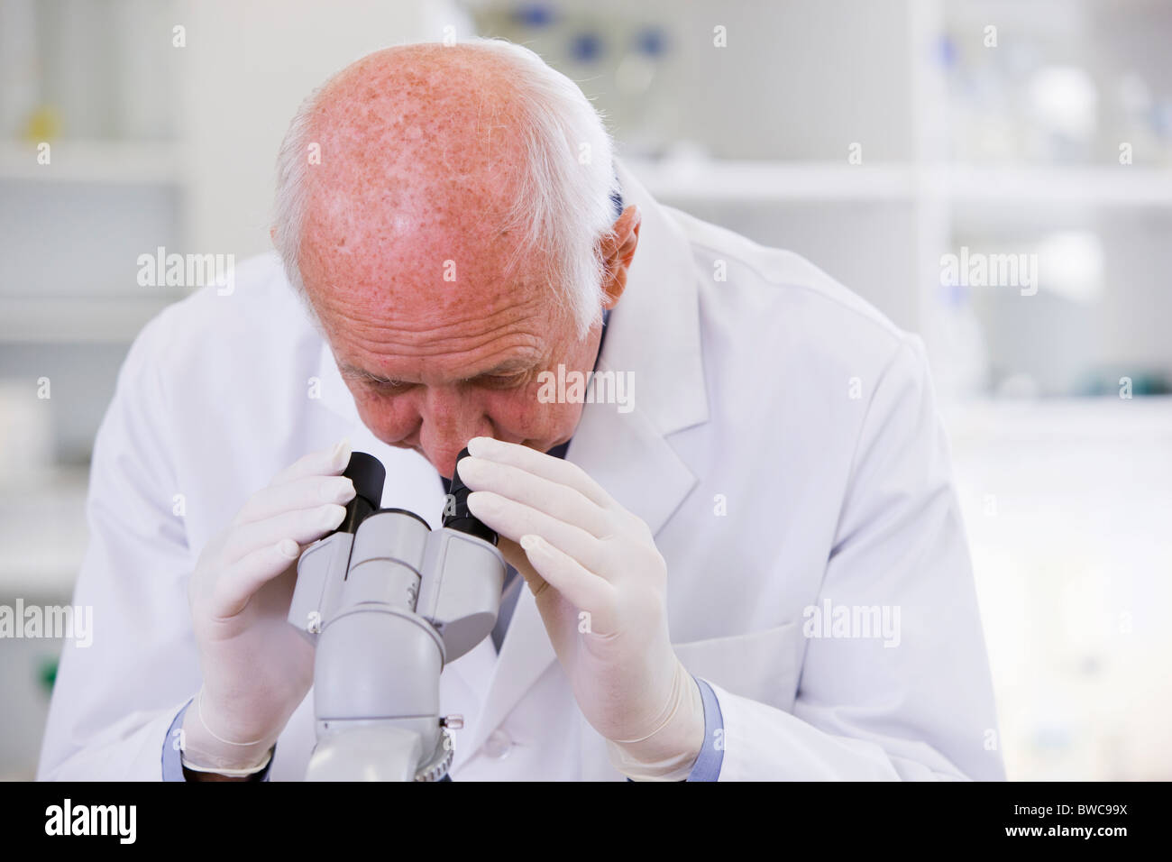 Male scientist using microscope in laboratory Stock Photo - Alamy