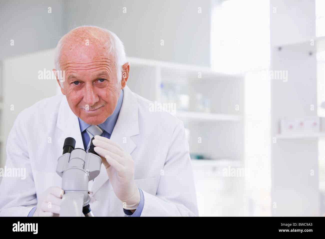 Male scientist using microscope in laboratory, portrait Stock Photo - Alamy