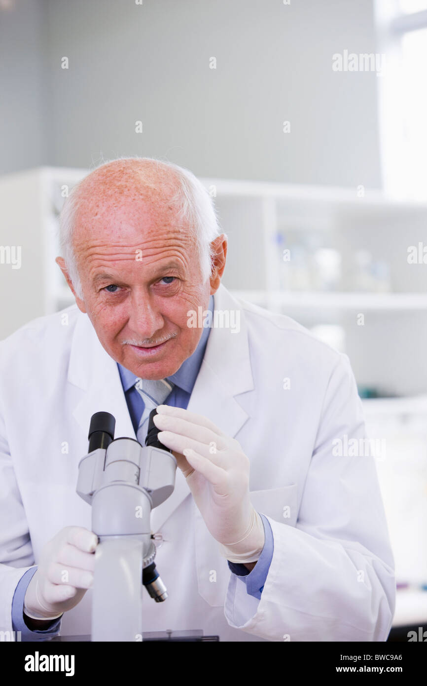Male scientist using microscope in laboratory, portrait Stock Photo - Alamy