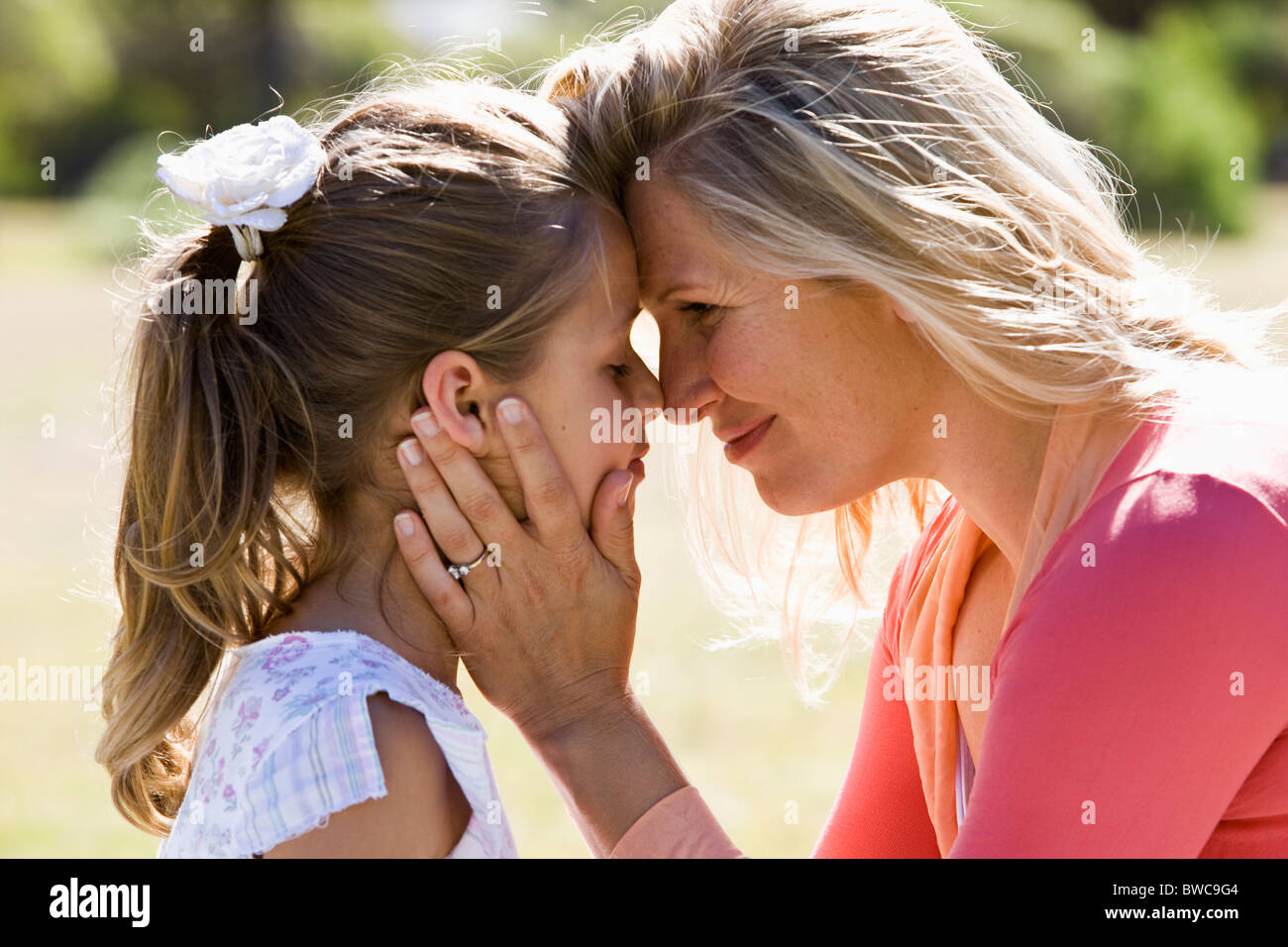 Mother and daughter (8-9) face to face Stock Photo - Alamy