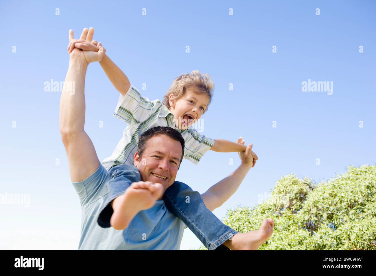 Father Carrying His Child On Arms High Resolution Stock Photography and ...