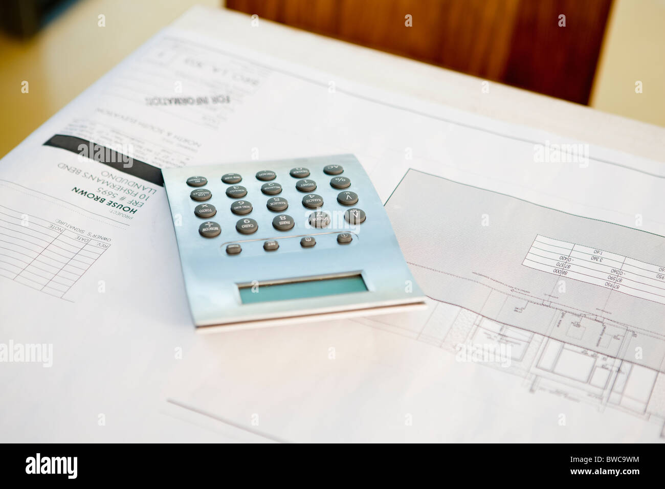 Calculator on blueprint Stock Photo - Alamy