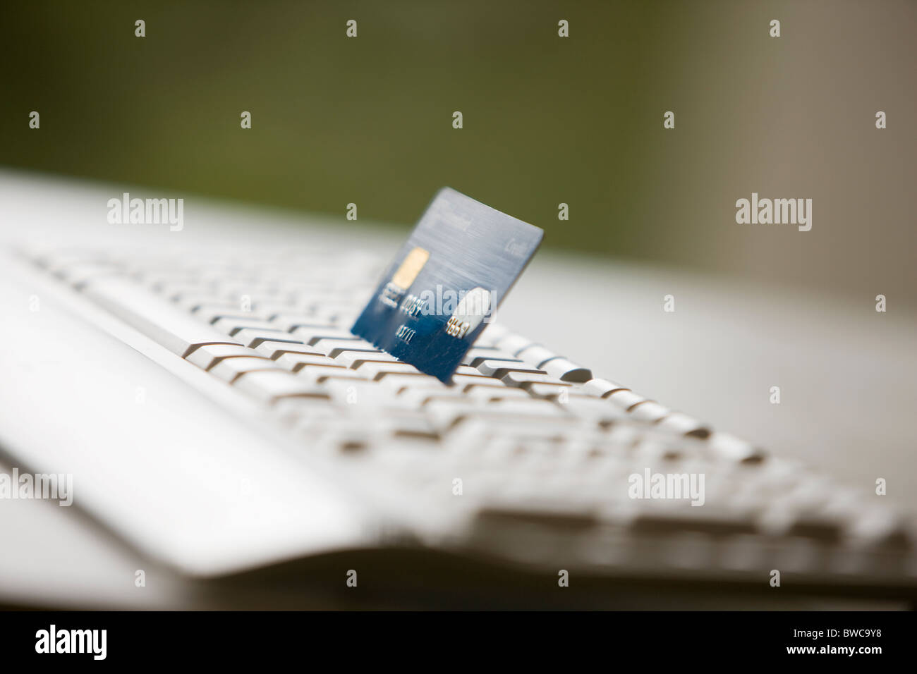 Credit card put in computer keyboard, close-up Stock Photo - Alamy