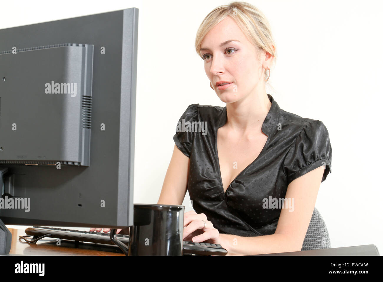 Business Woman at a Desk with computer in an office Stock Photo - Alamy