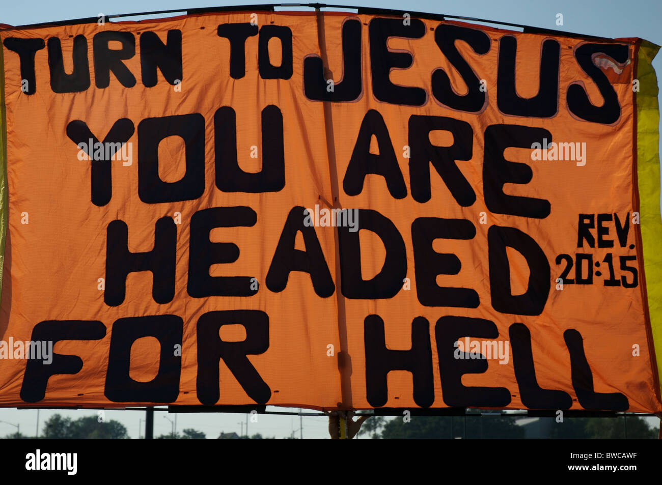 A sign reading "Turn to Jesus. You are Headed for Hell" is displayed at ...