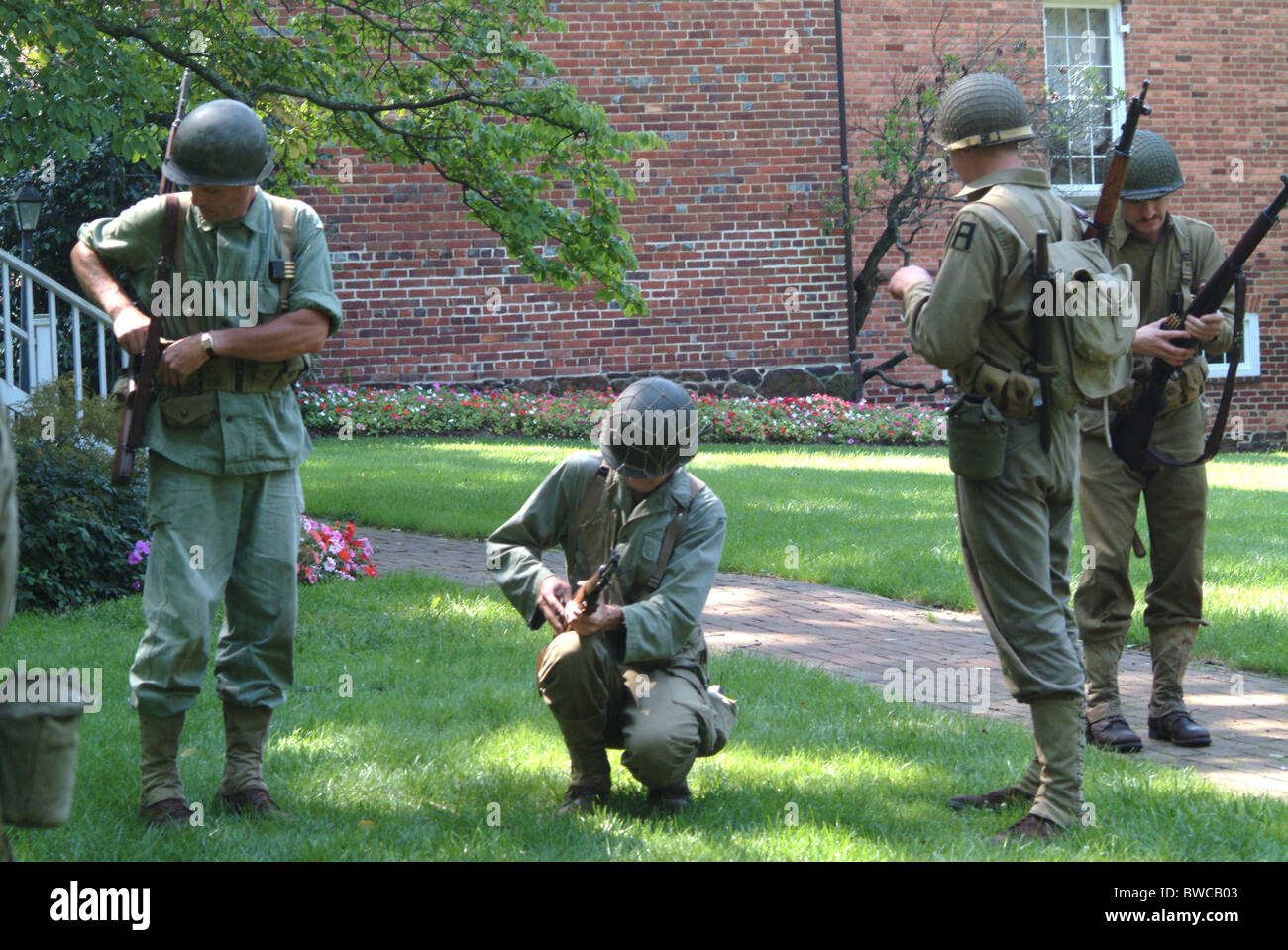 GI's load their weapons preparing to search for Nazis in WWII ...