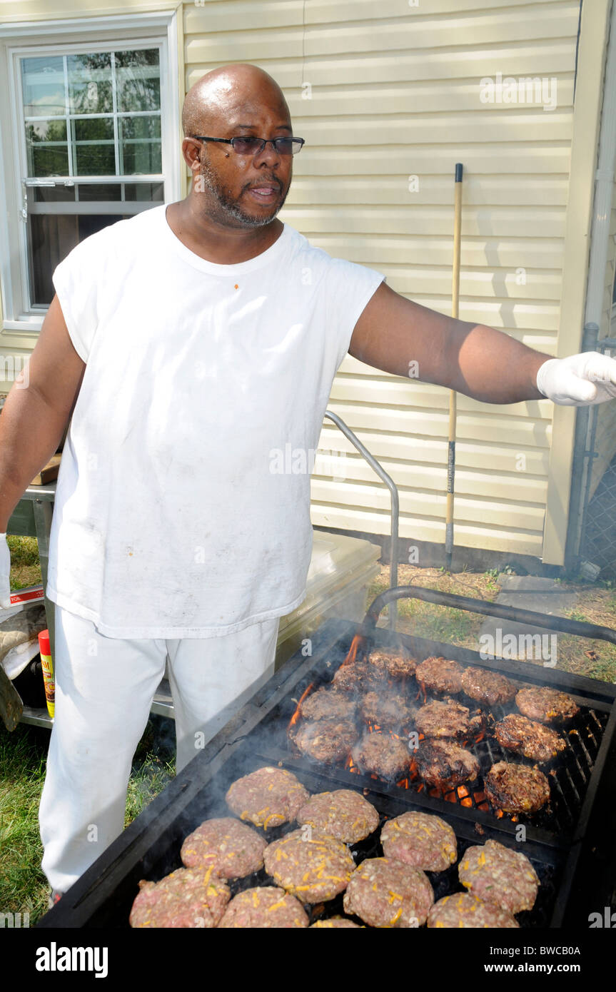 Man grills hamburgers at an outdoor barbecue in Bowie, Maryland Stock ...