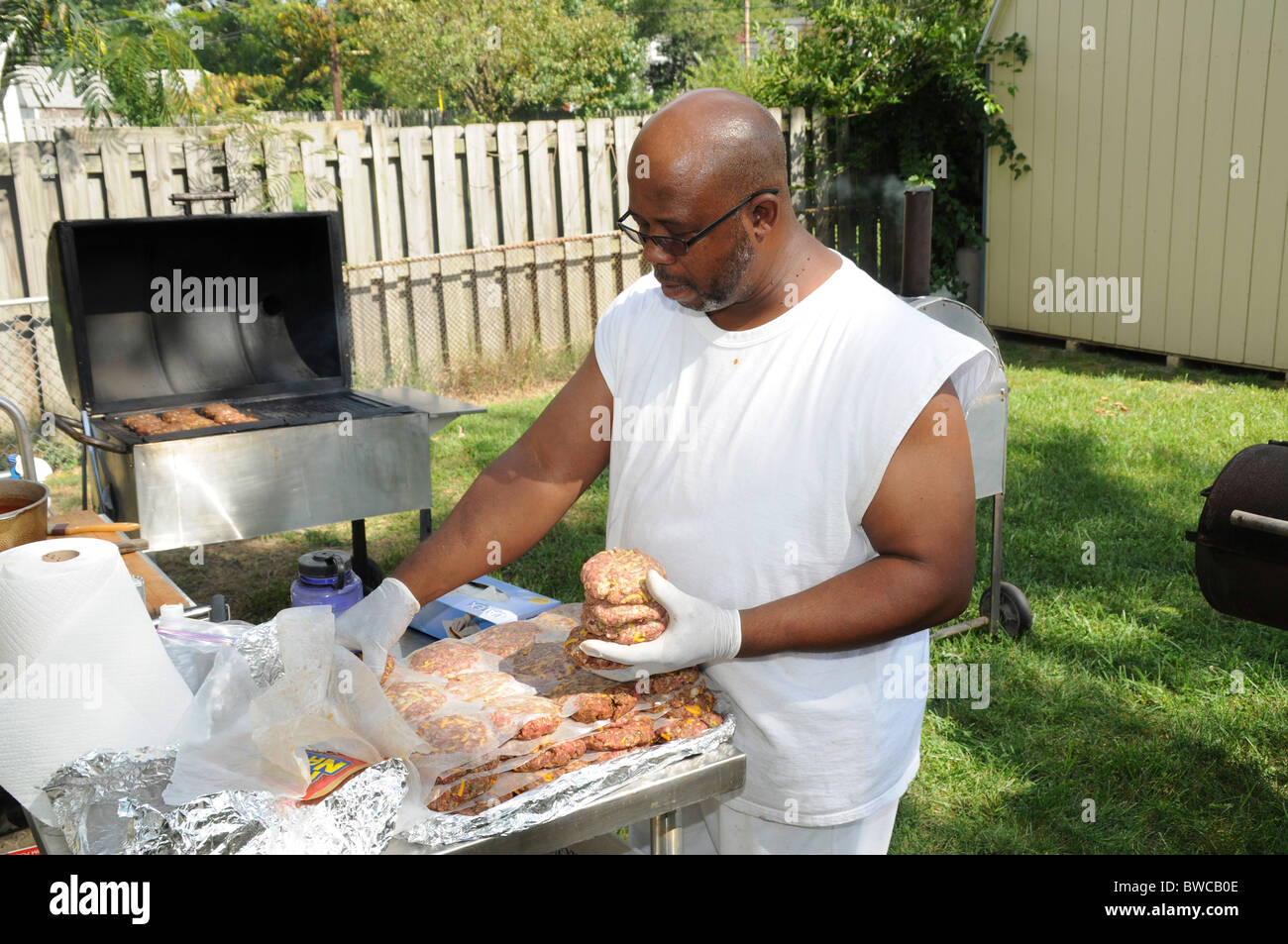 Man grills hamburgers at an outdoor barbecue in Bowie, Maryland Stock ...
