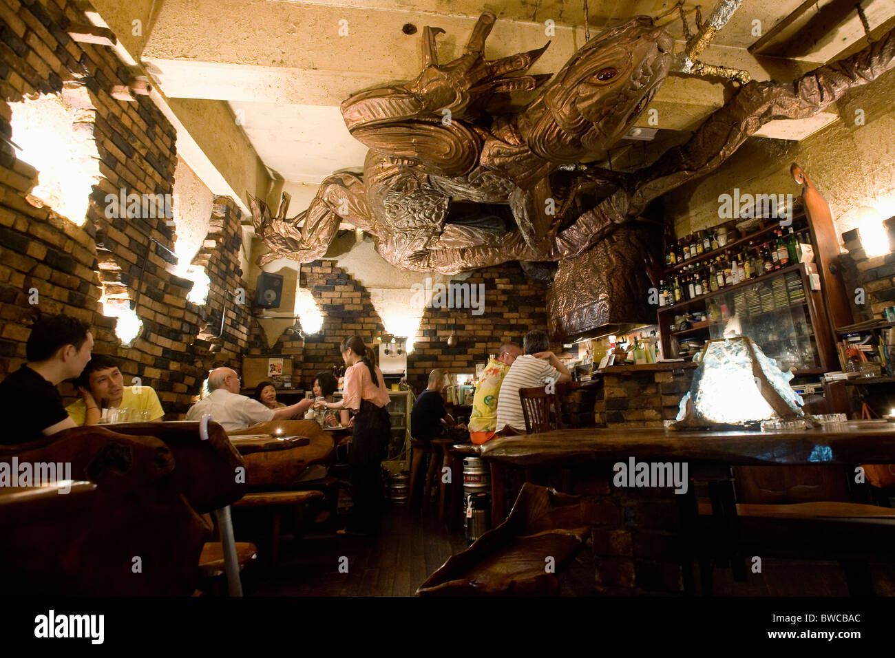 A giant metal reptile graces the ceiling of Mother's Revenge bar in ...