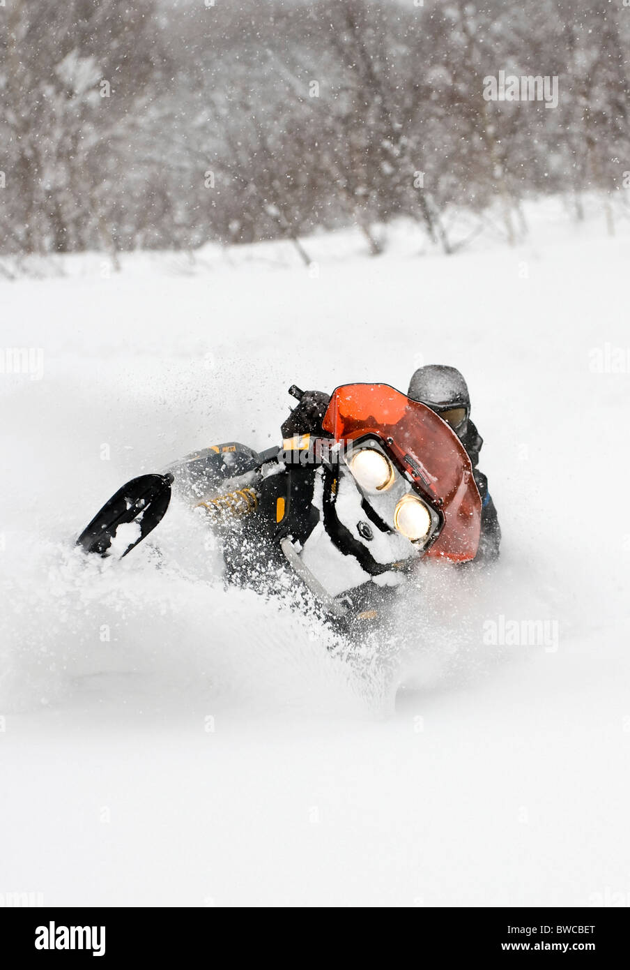Resort staff lead the way during a snowmobile tour at Hanazono resort ...