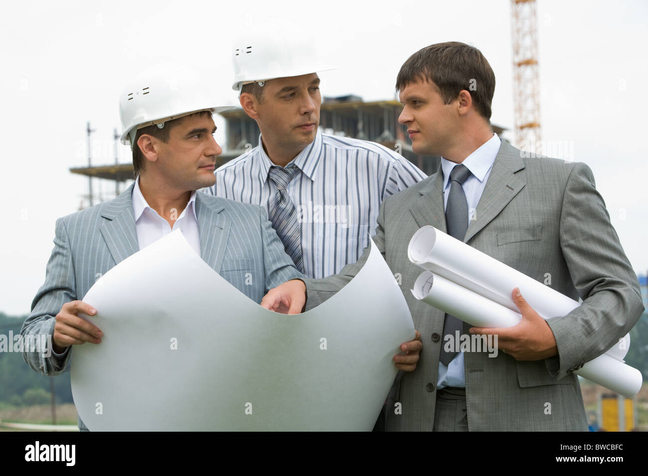Image of three workers looking at each other during discussion of ...