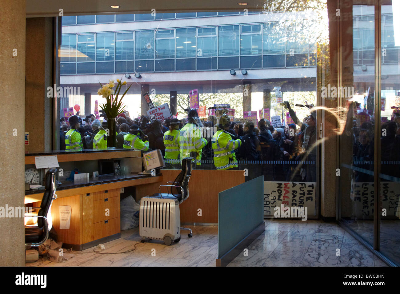 Windows being smashed during student protests against tuition fees ...