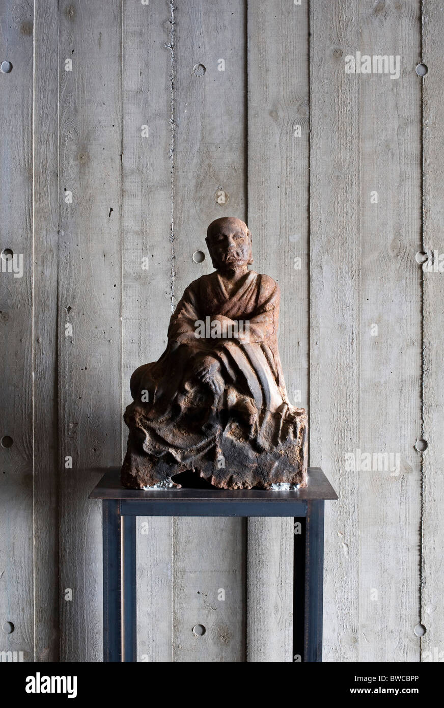 A luo-han cast-iron Buddhist statue stands inside one of the 10 lofts ...