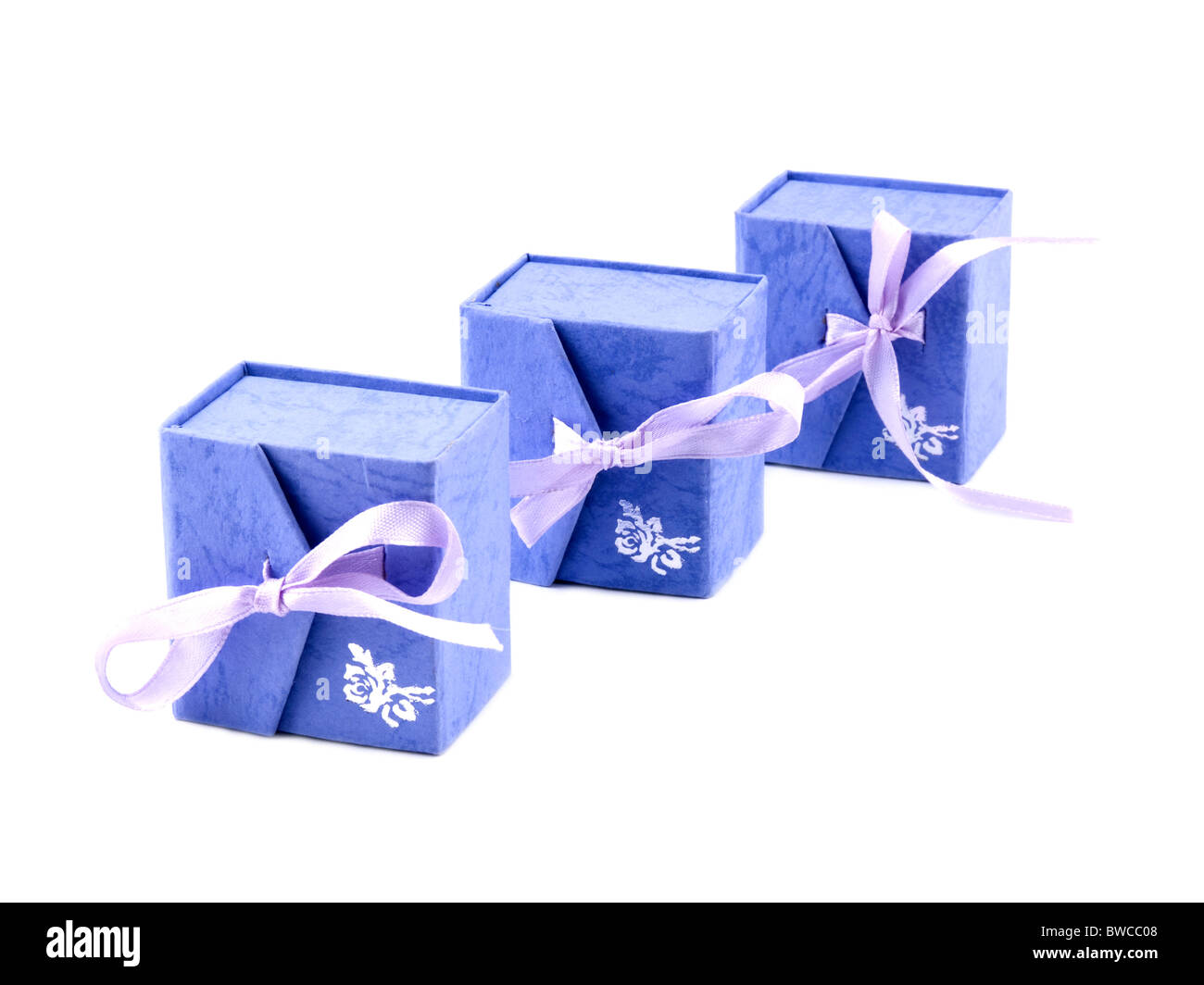 Three small lilac gift boxes on white background Stock Photo - Alamy