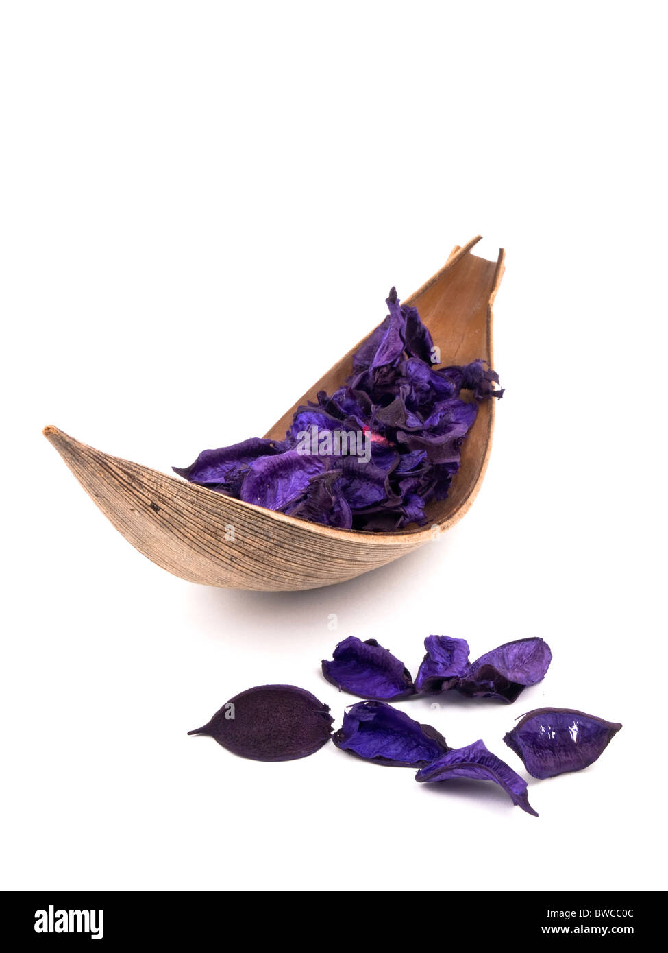 Aromatic purple potpourri in wooden decoration on white background ...
