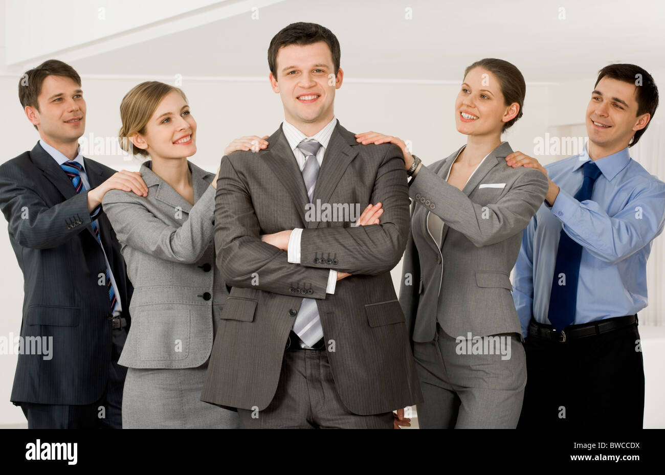Portrait of smart business people keeping their hands on each others ...