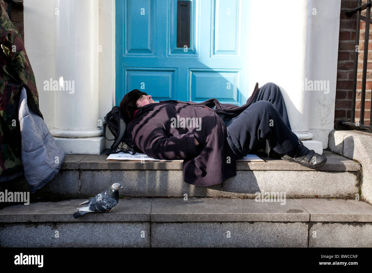 Homeless man sleeping on a doorstep opposite Irish Government buildings ...