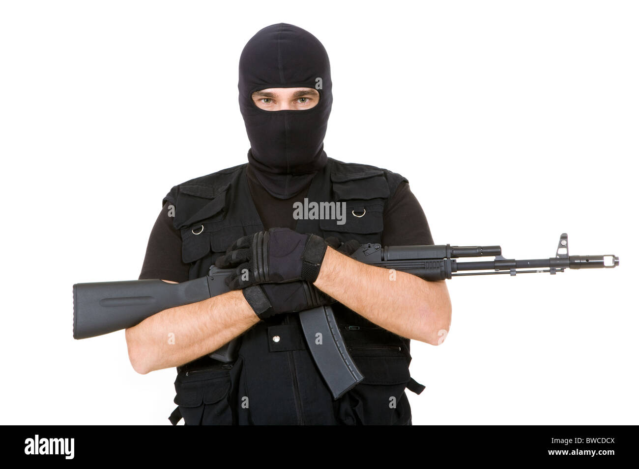 Portrait of violent killer holding firearm and looking at camera with ...