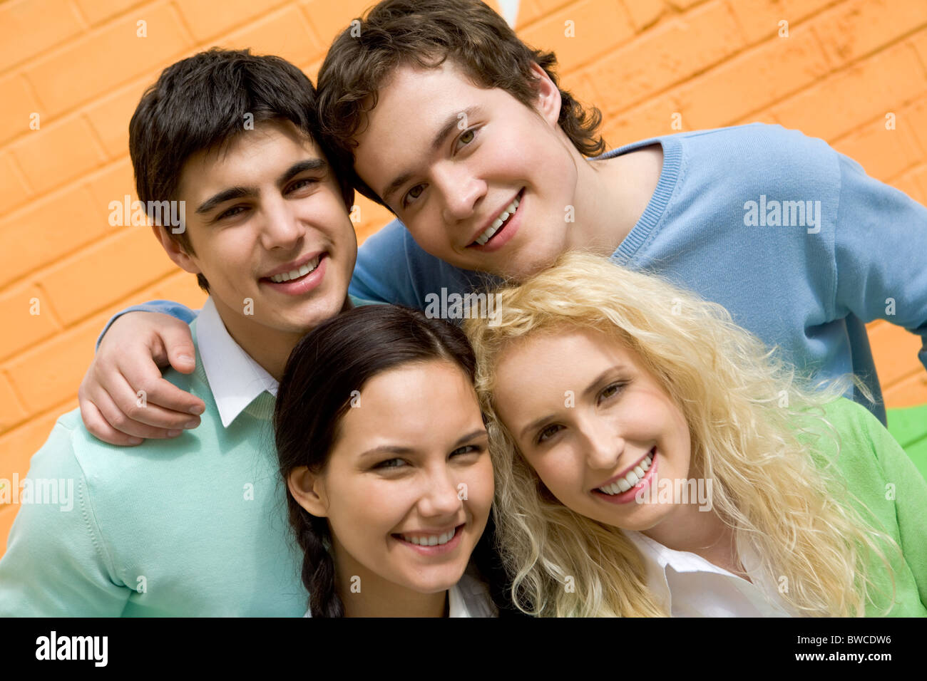 Portrait of friendly students looking at camera with happy smiles Stock ...