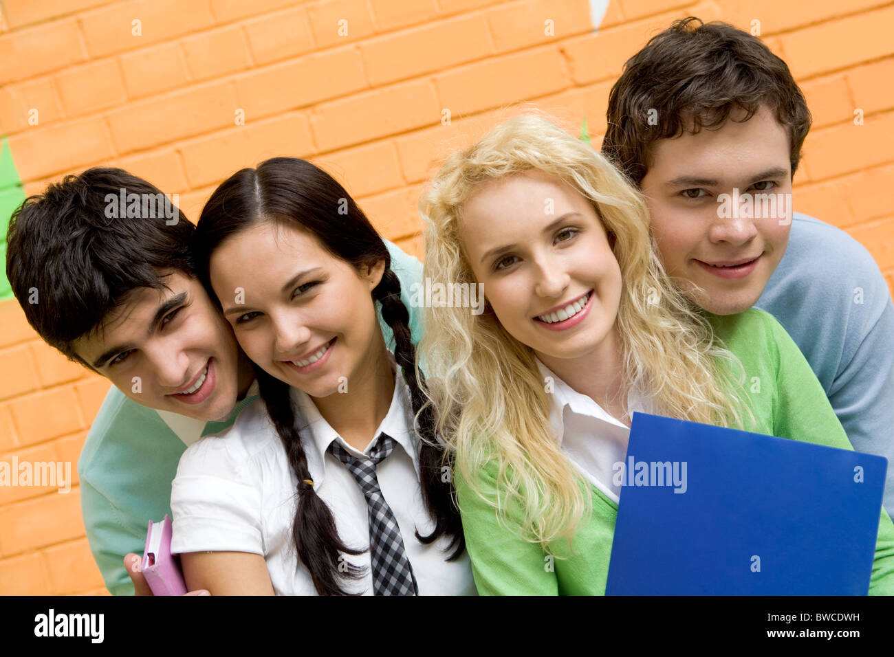 Portrait of friendly students looking at camera with happy smiles on ...