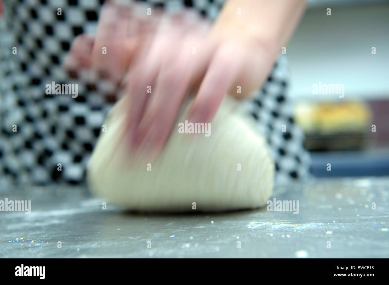 Traditional bakery baker in kitchen kneadjng dough, Devon, uk Stock ...